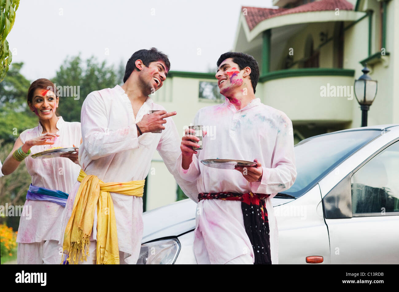 Friends celebrating Holi Stock Photo - Alamy