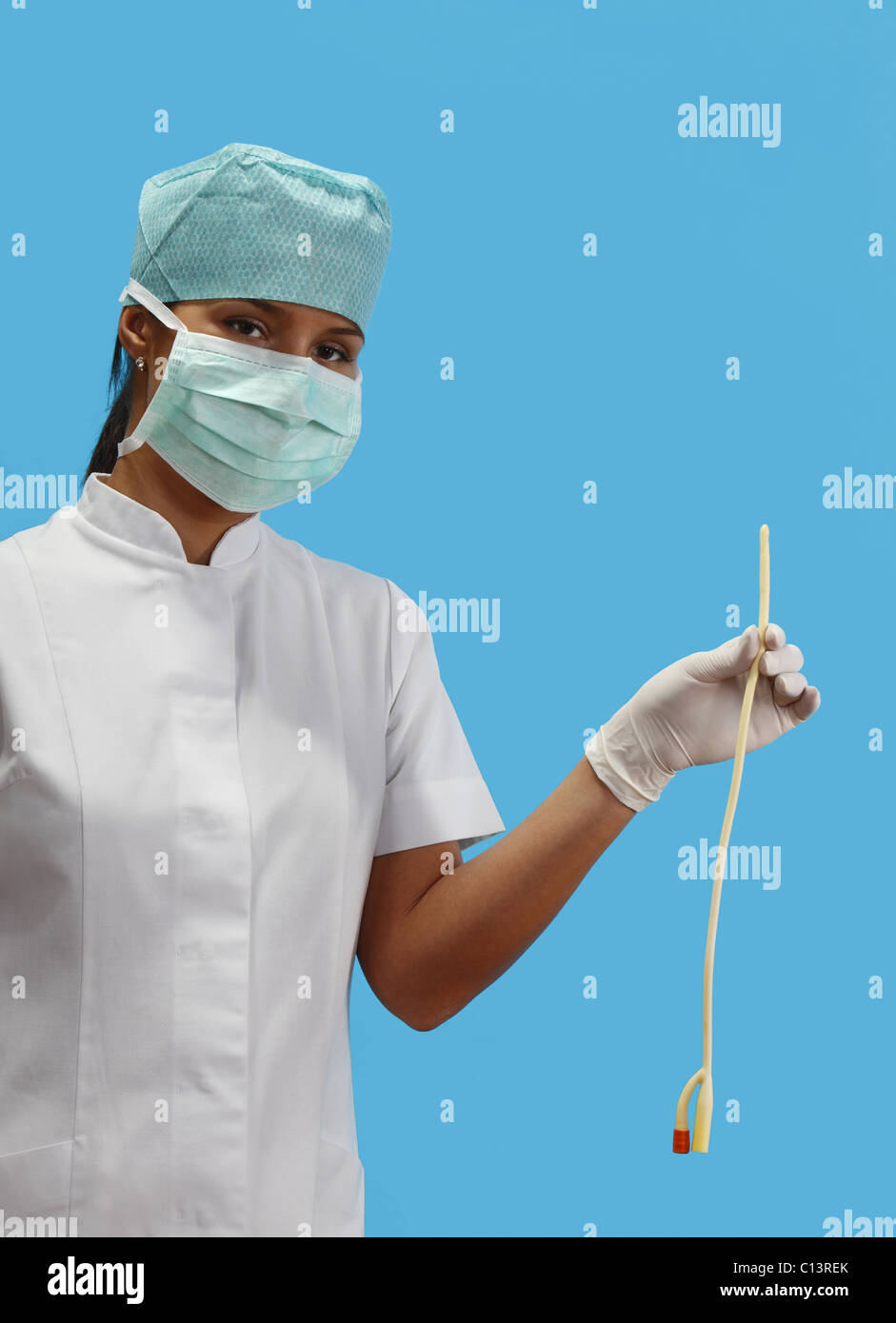 Image of a female nurse holding an urinary catheter isolated against a ...