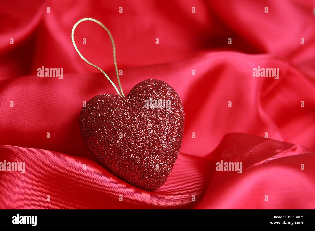 Beautiful red silk fabric background with a Valentine heart Stock Photo ...
