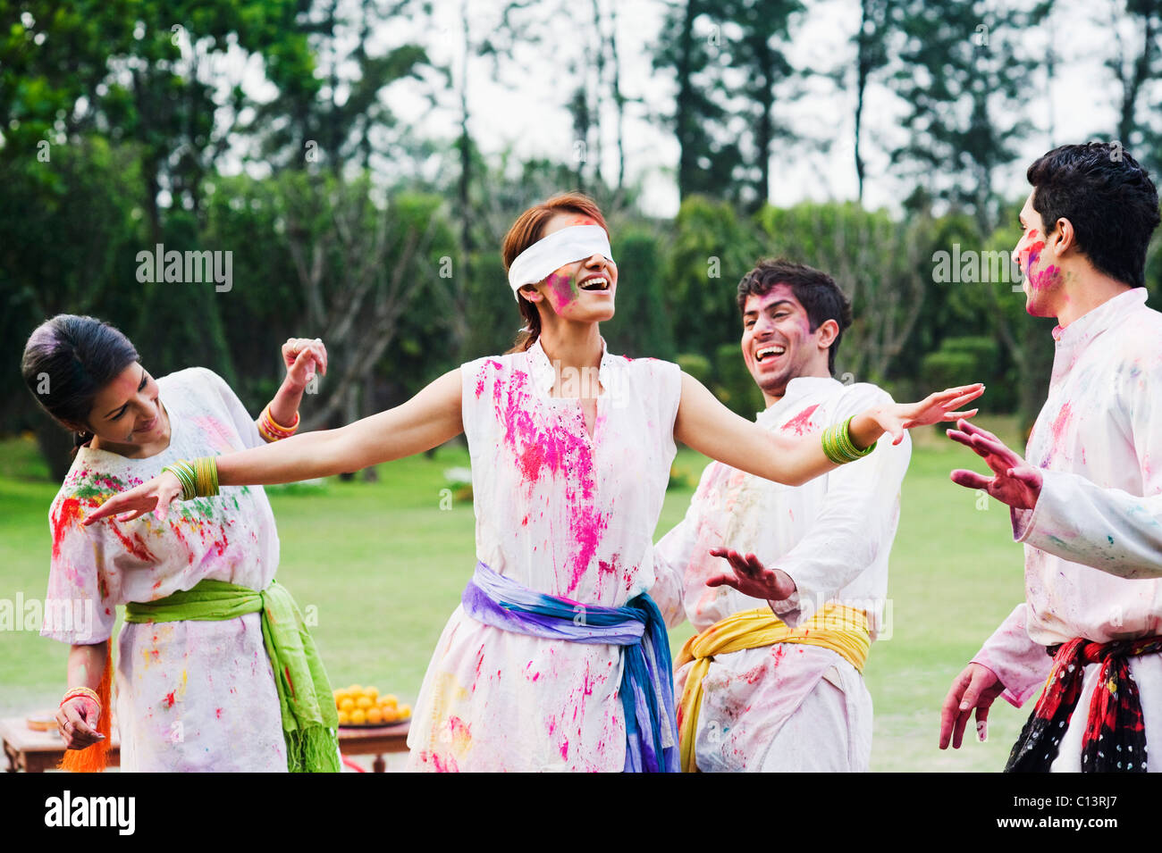 Friends celebrating Holi Stock Photo - Alamy