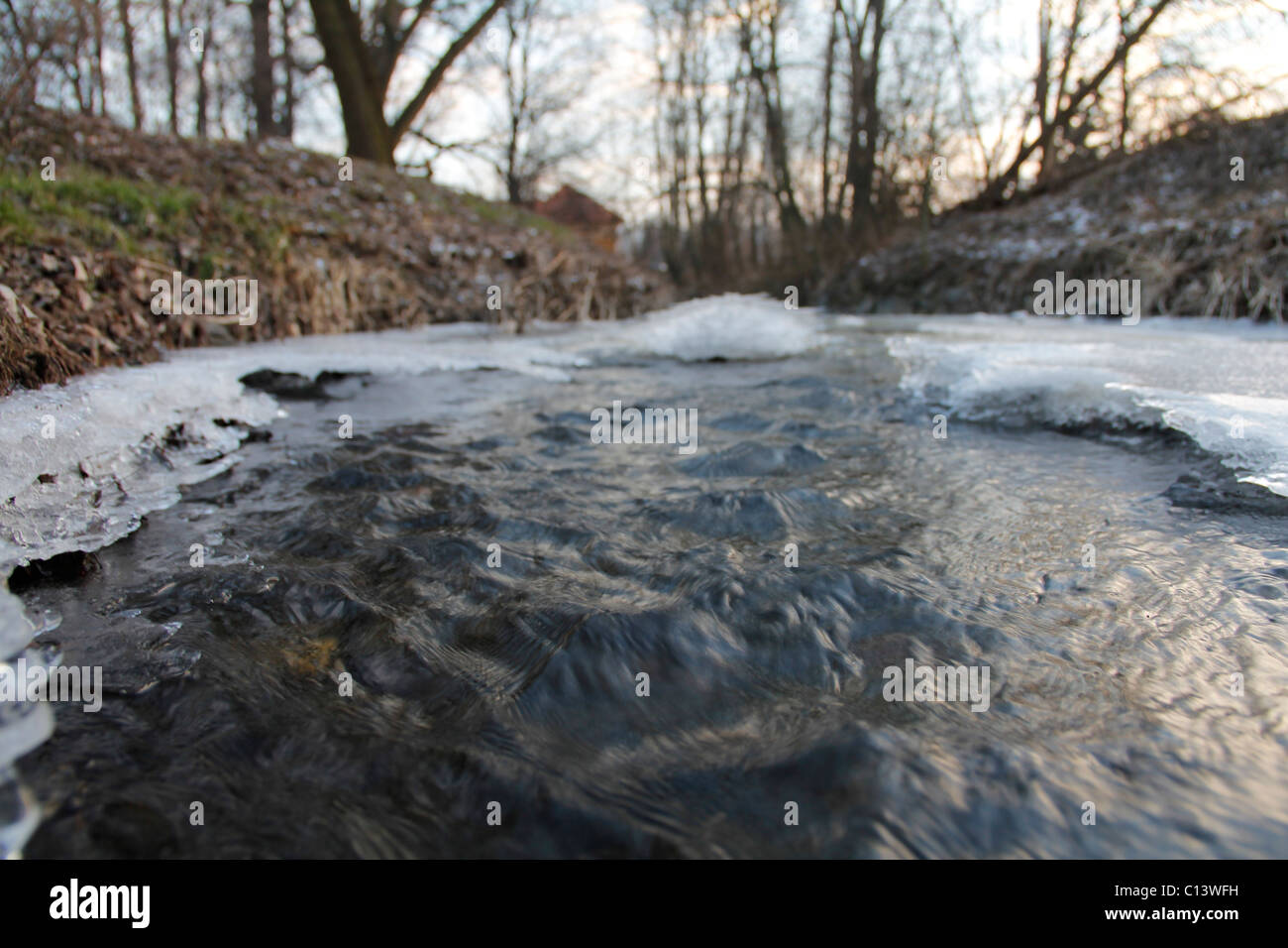 Beautiful water flows away to meet spring Stock Photo - Alamy