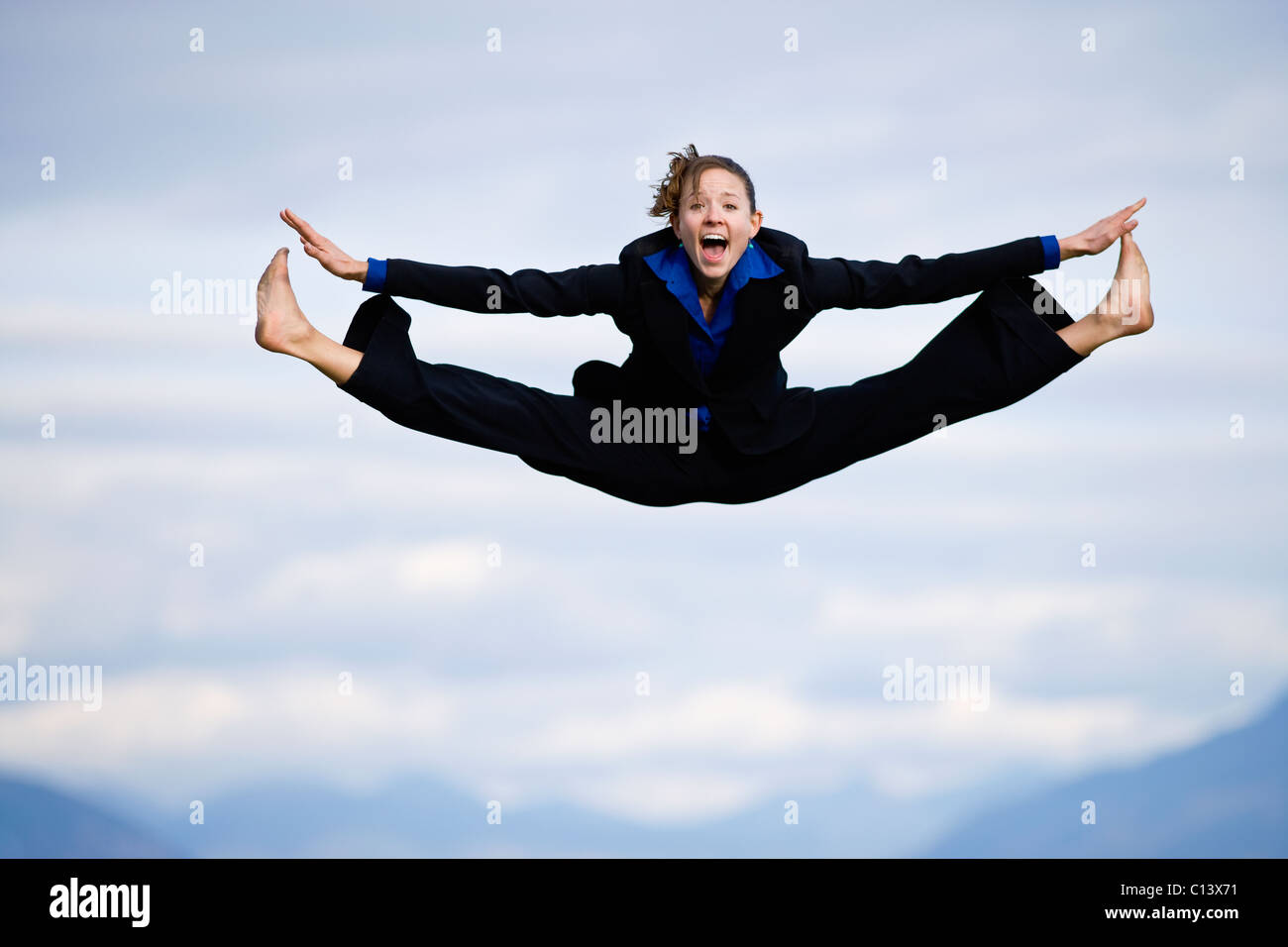 USA, Montana, Whitefish, businessman mid-air doing splits Stock Photo ...