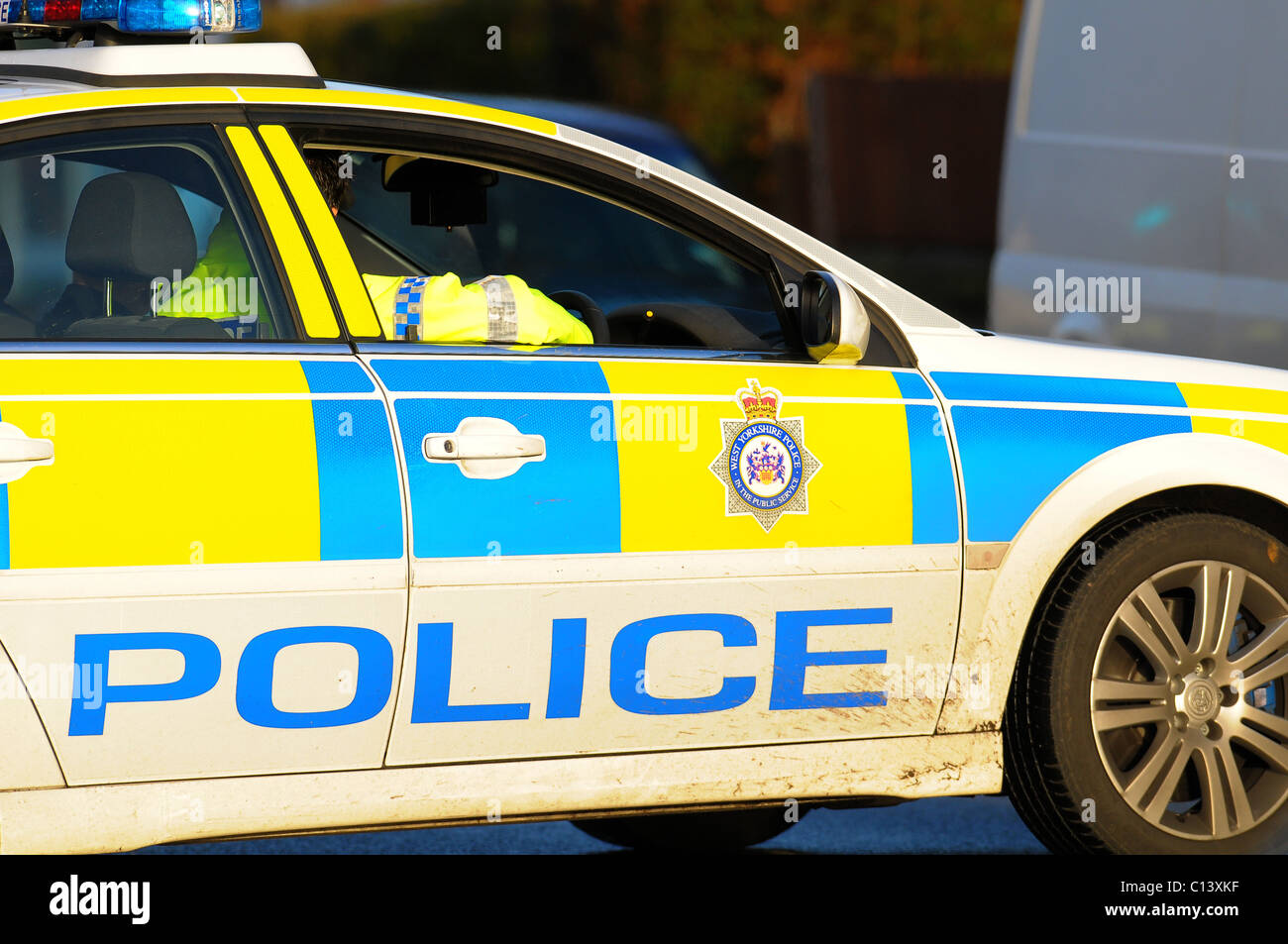 Speed Cop watching a driving accident while on radio Stock Photo - Alamy