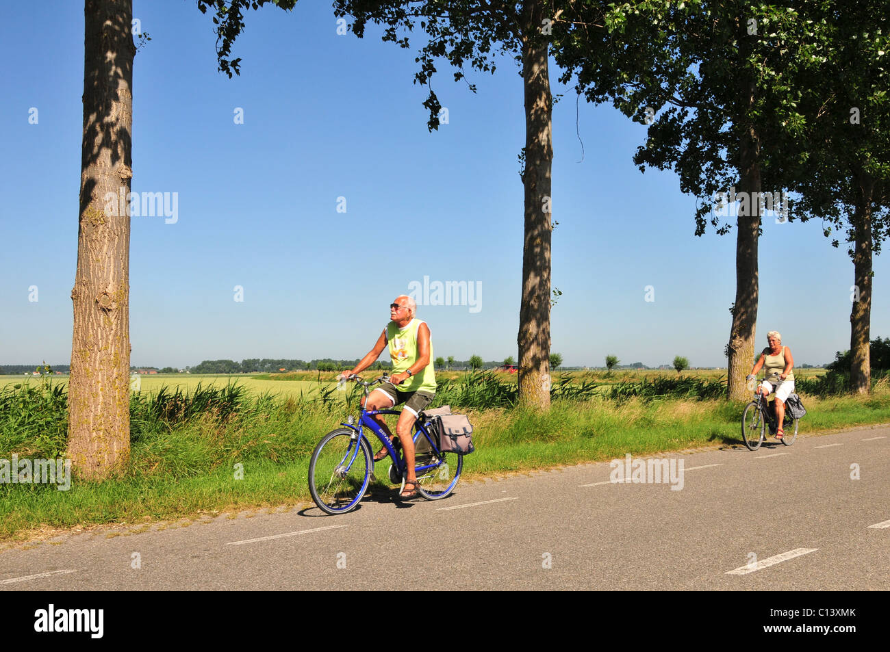 Two senior cyclists riding their bicycles Stock Photo - Alamy