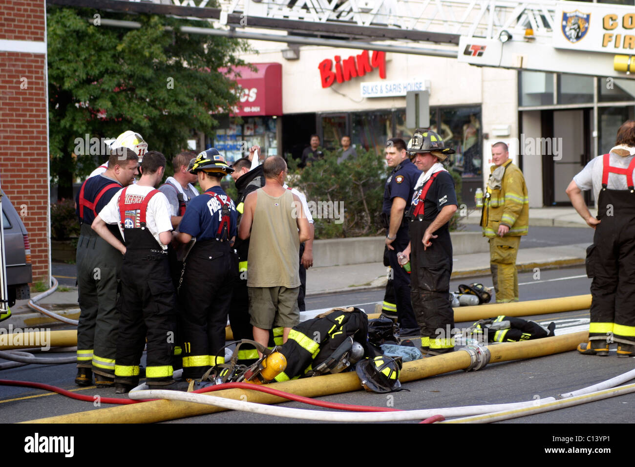 Firefighters packing away gear at the scene of a fire Stock Photo - Alamy