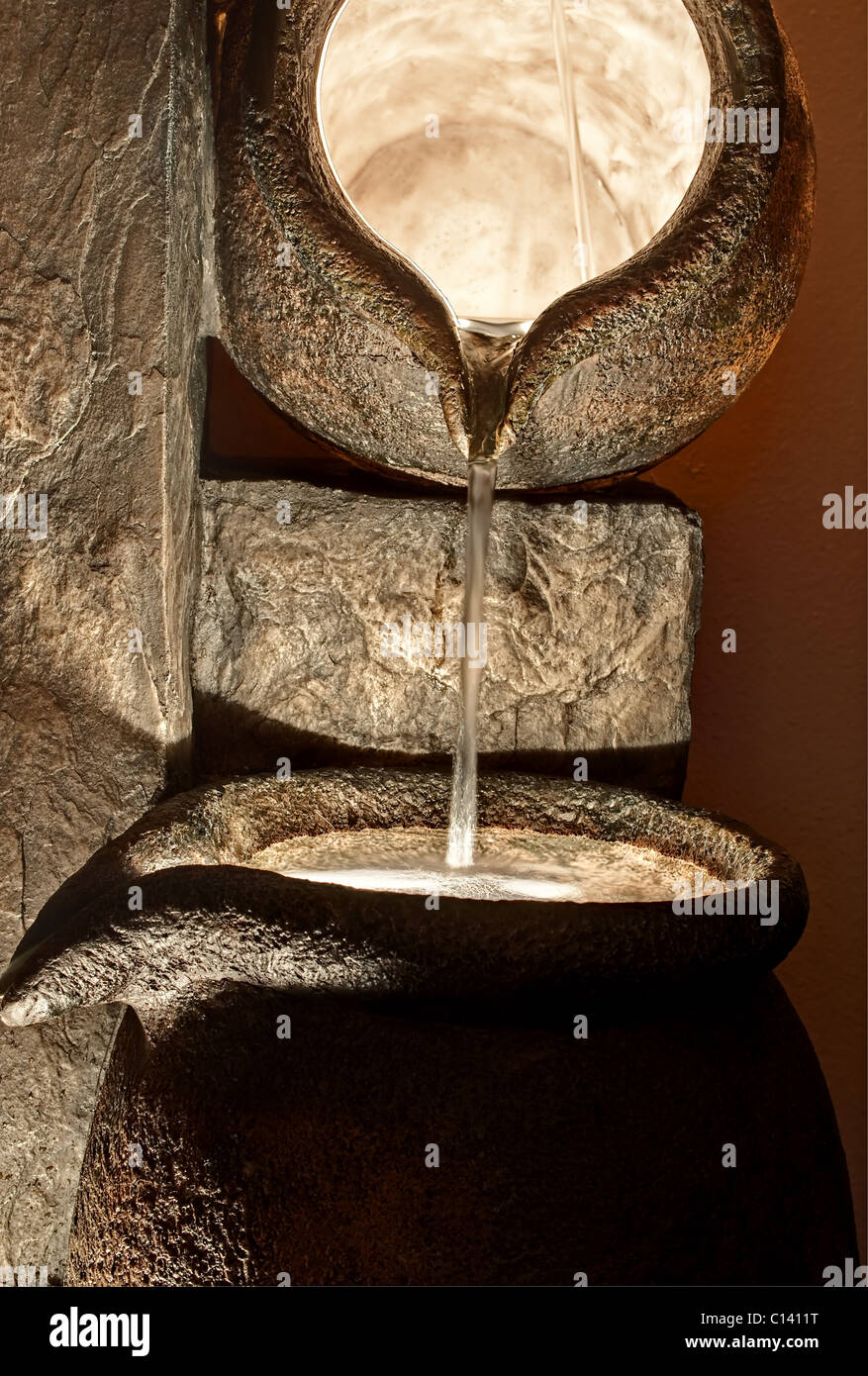 Large stone pottery pots with water spilling out of one vessel into the ...