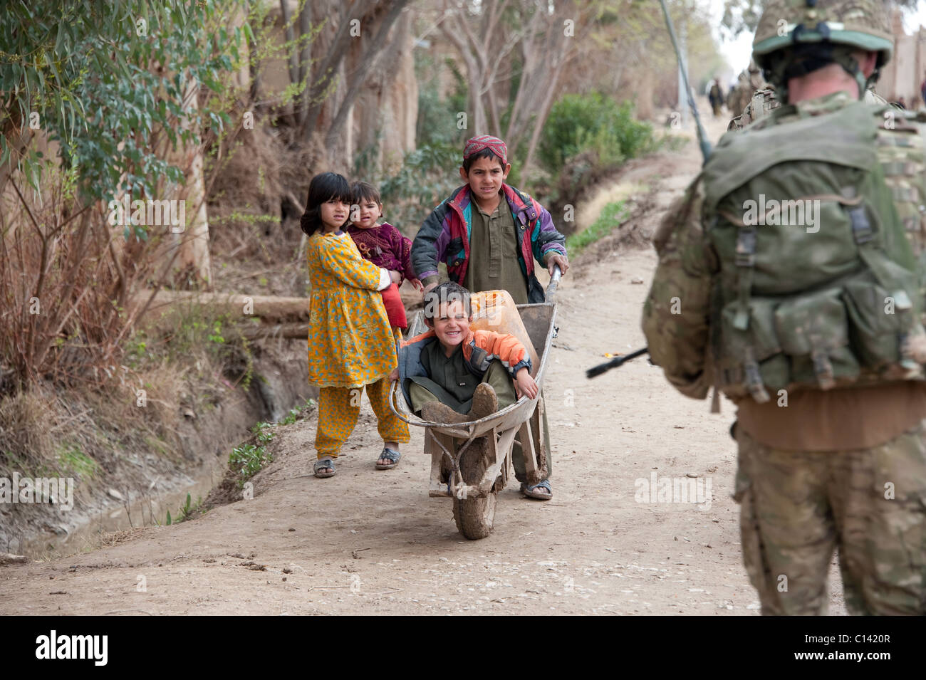 Children in Helmand meet ISAF soldiers in Afghanistan Stock Photo - Alamy