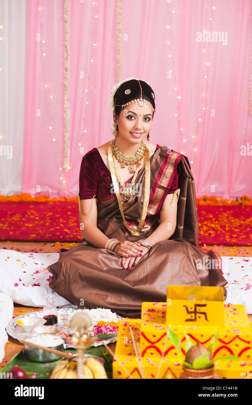 Bride sitting near a havan kund at the wedding mandap Stock Photo - Alamy