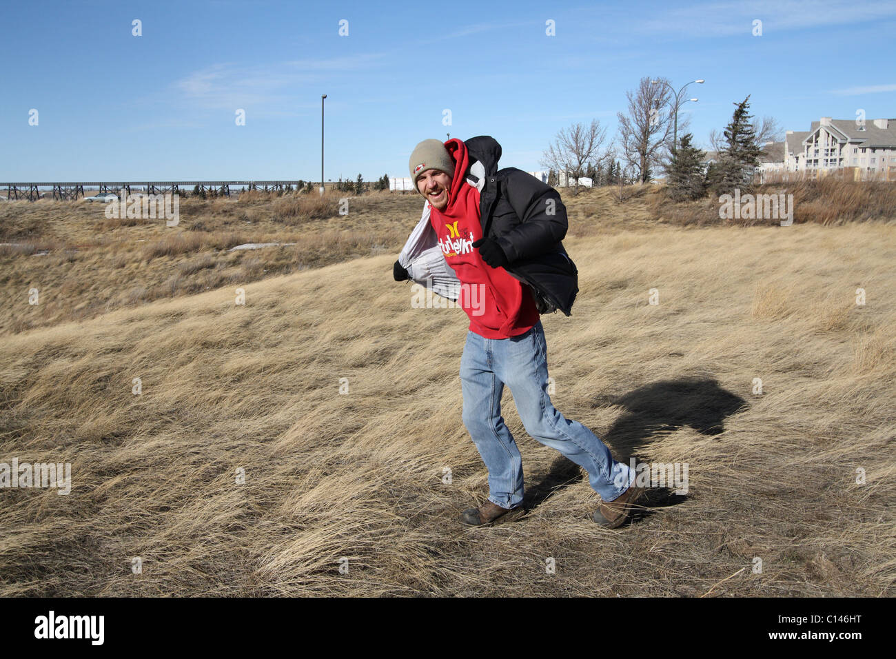 A man leaning into a strong wind Stock Photo - Alamy