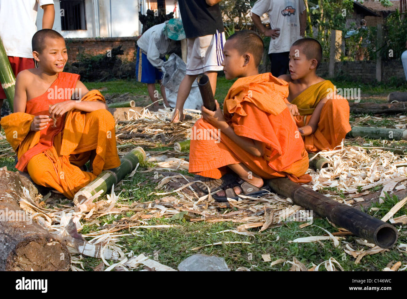 A group of young Buddhist monks are making bamboo rockets for a ...