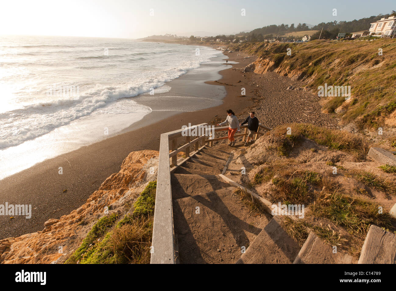 Boardwalk path along beach cliffs overlooking Pacific Ocean at ...