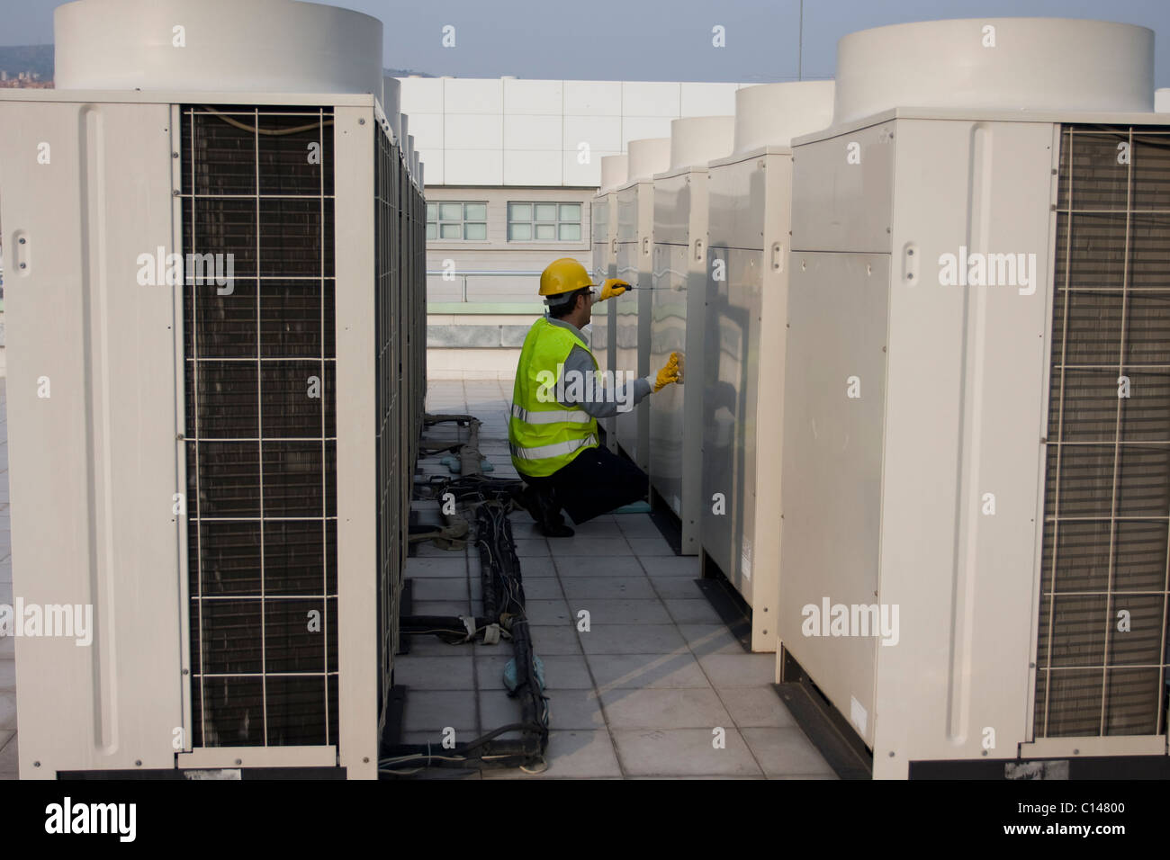 Air conditioner roof technician hi-res stock photography and images - Alamy