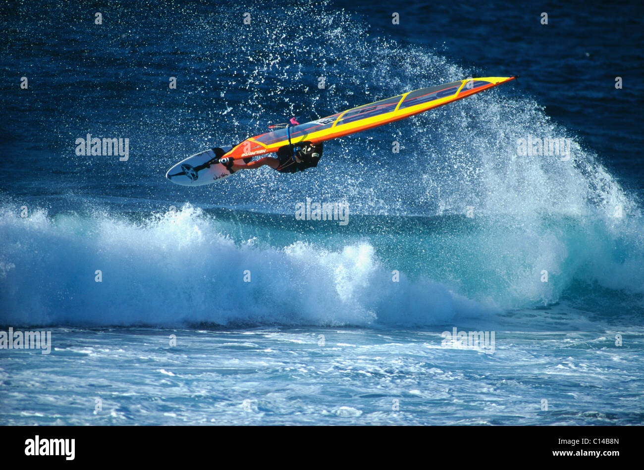 windsurfer flies free of a breaking wave at Hookipa, Hawaii, USA Stock ...