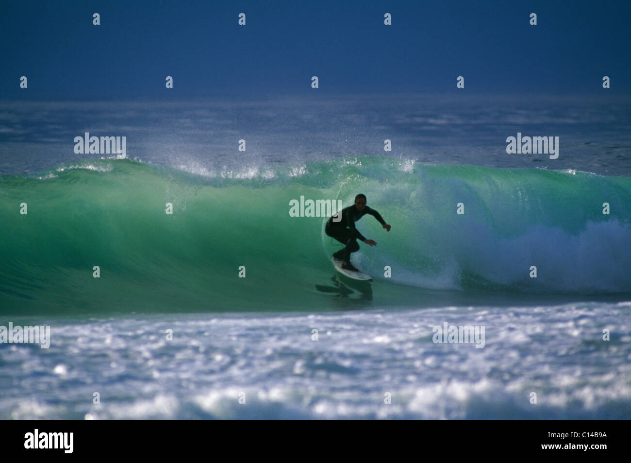 Surfer racing green wave in France. Surfing is the most popular beach ...