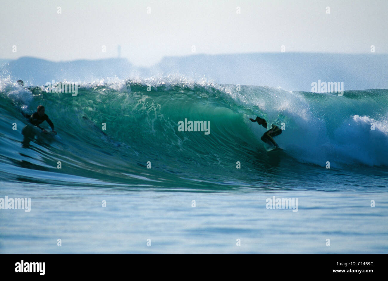 Surfing in UK. Tube ride on Gower, Wales Stock Photo - Alamy