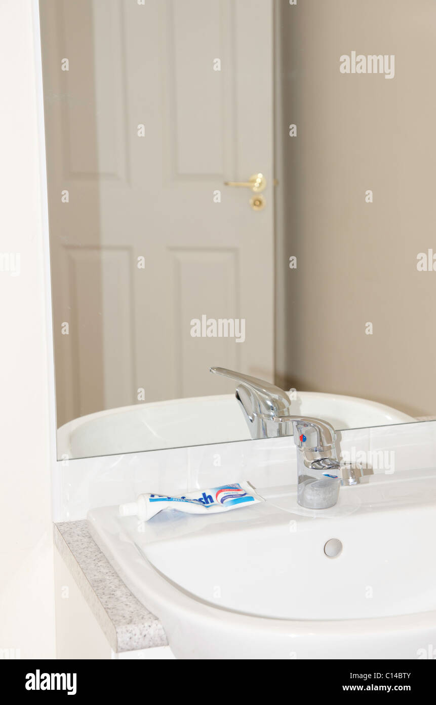 Toothpaste tube on the sink Stock Photo - Alamy