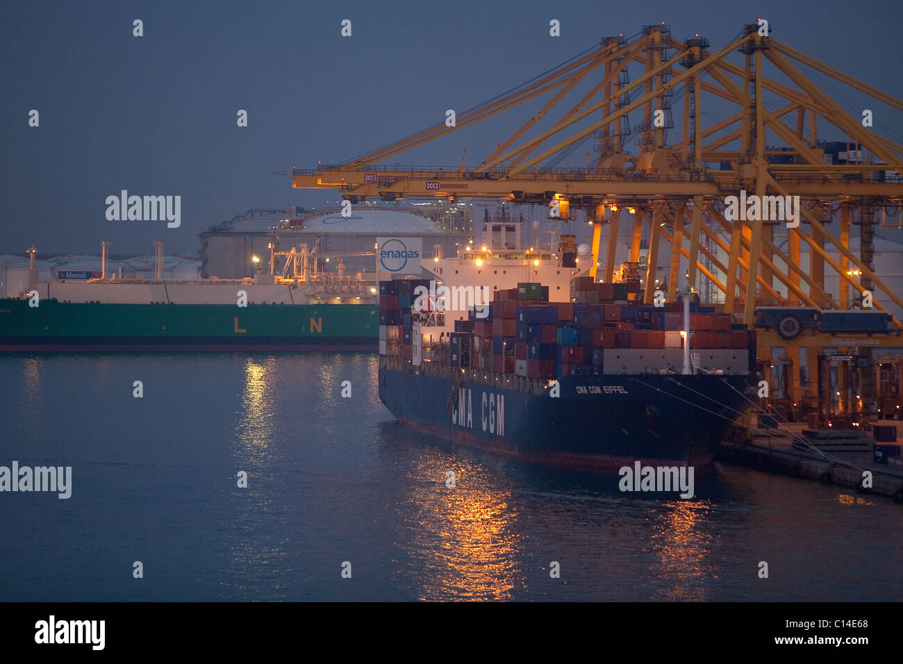 Very early morning at Barcelona Harbour. Container ship discharging ...