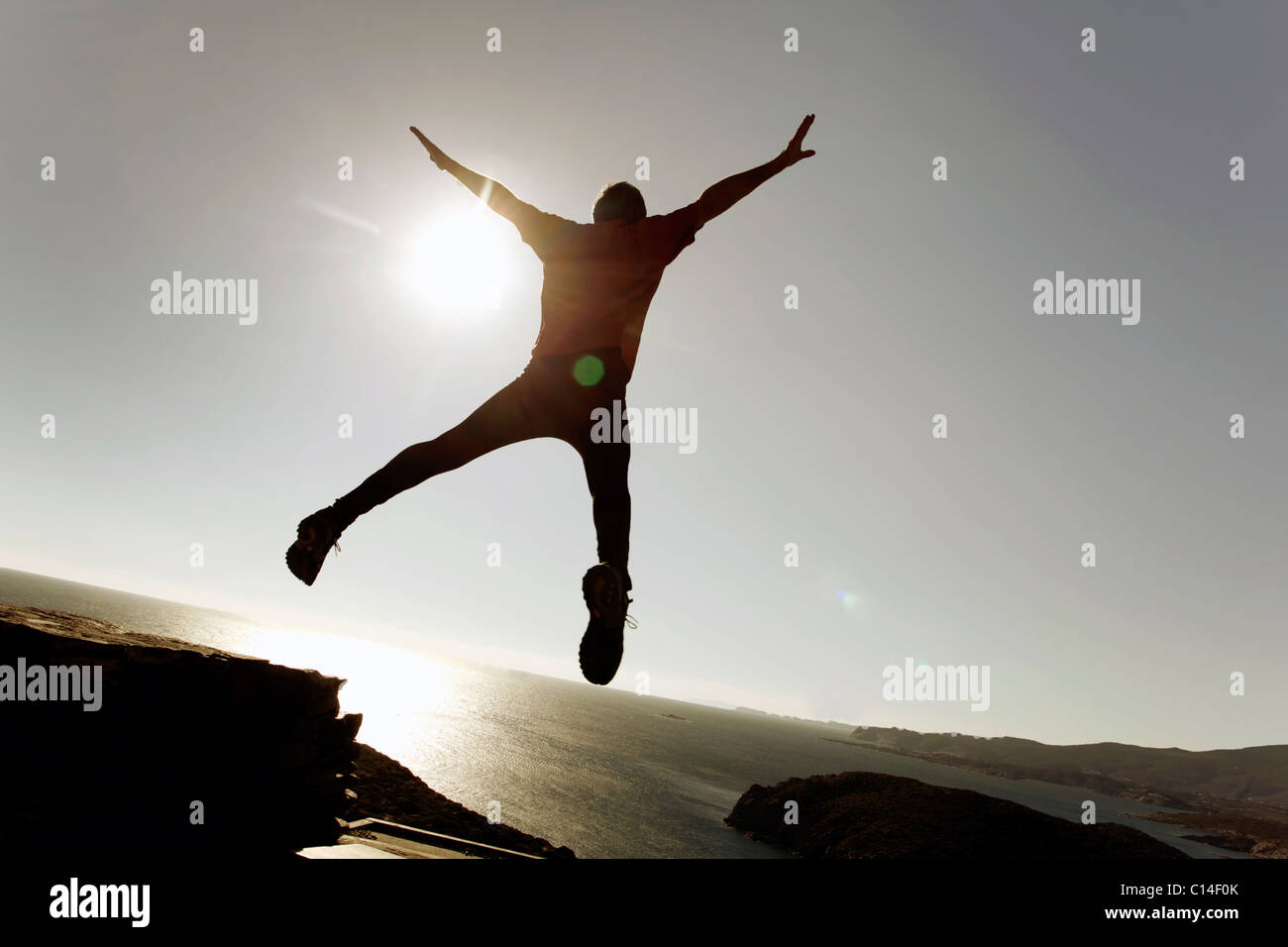 Man leaping through the air by the sea Stock Photo - Alamy