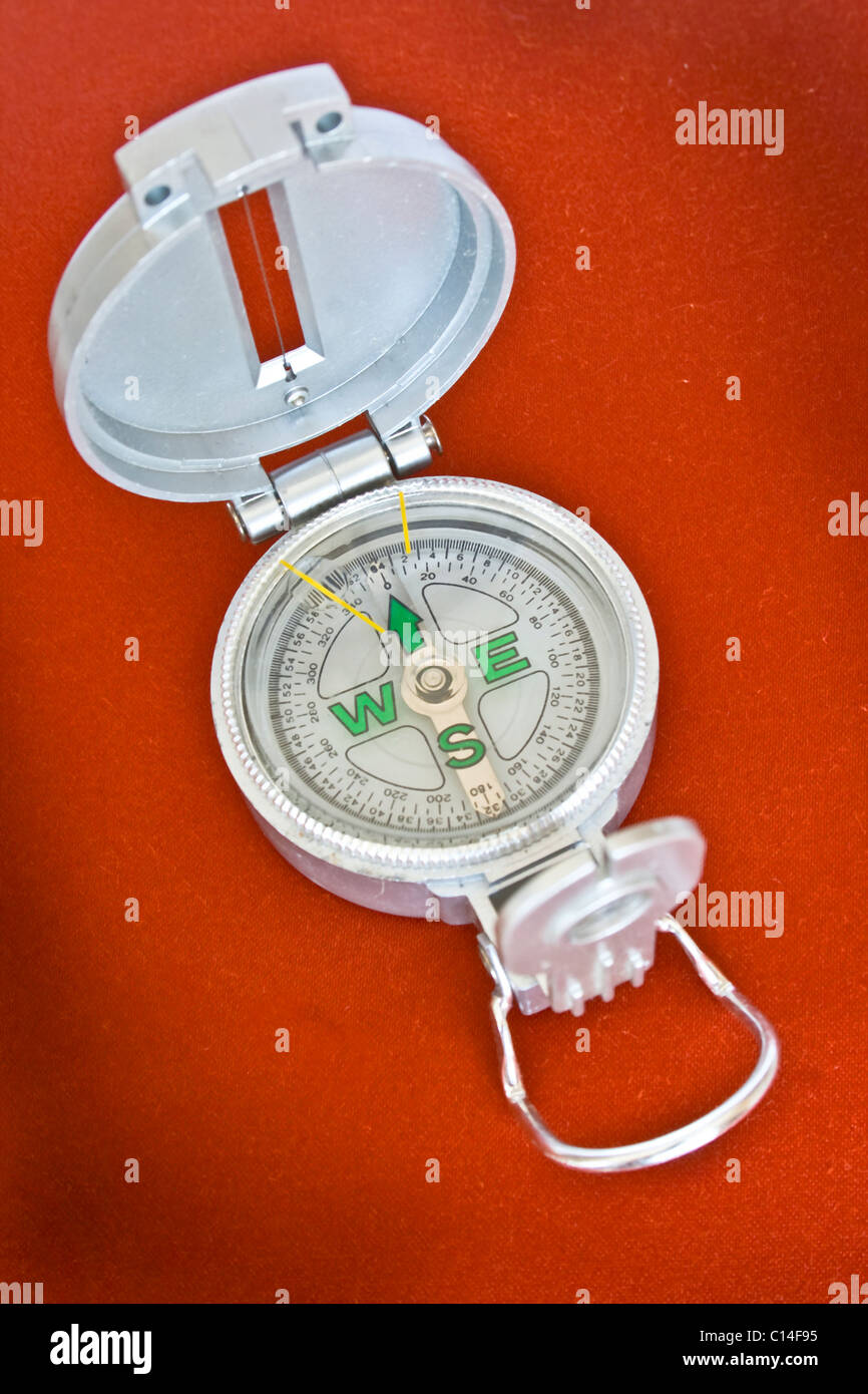 aluminium cased compass pointing north on a tan backdrop Stock Photo ...