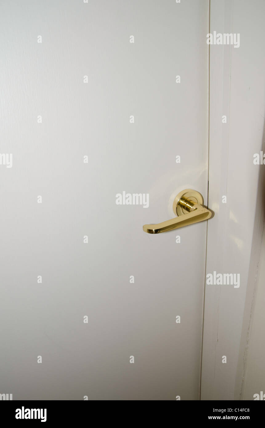 Brass door handle with locking device Stock Photo - Alamy