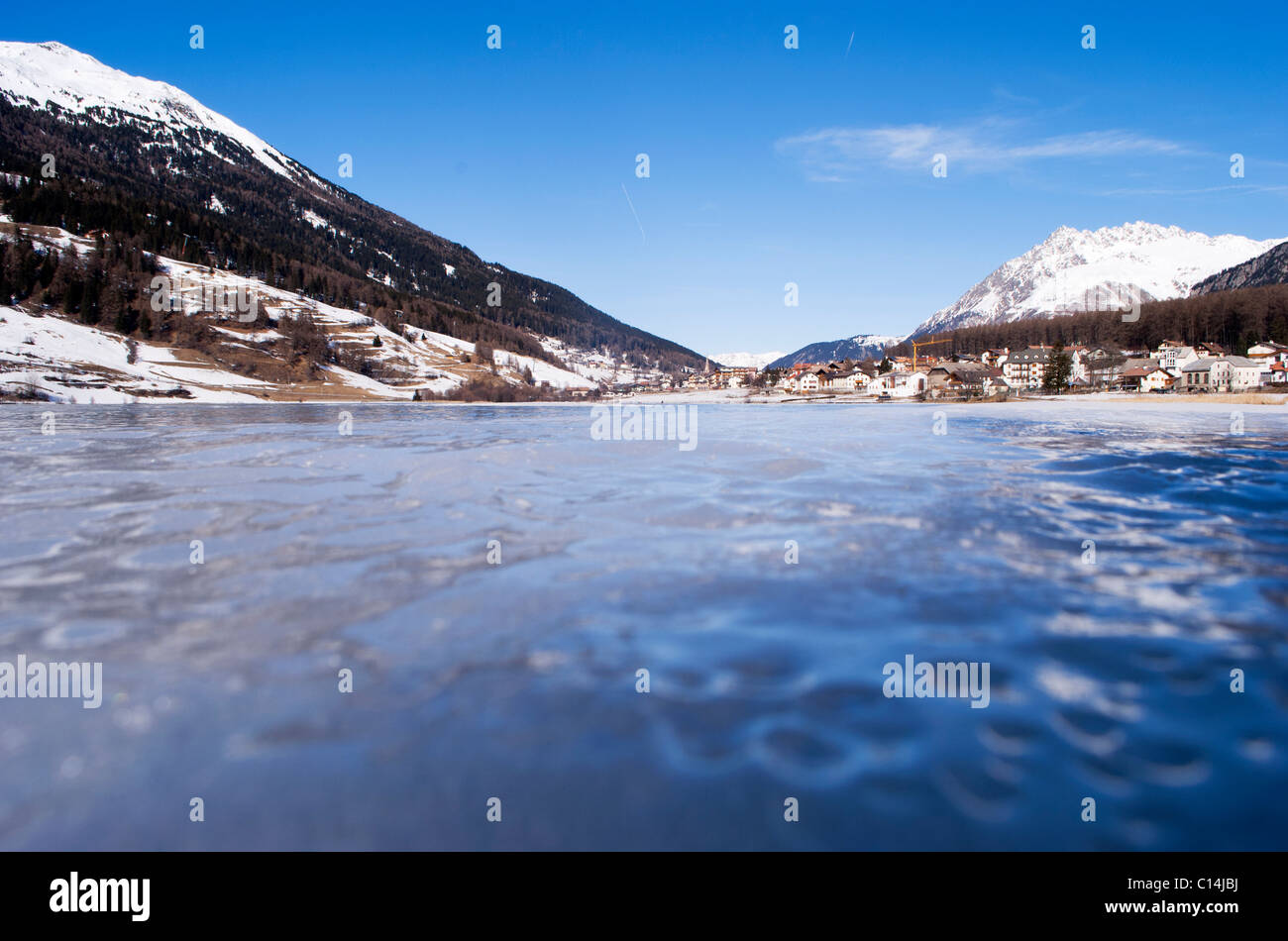 frozen lake in winter with the Alpine mountains and blue sky Stock ...