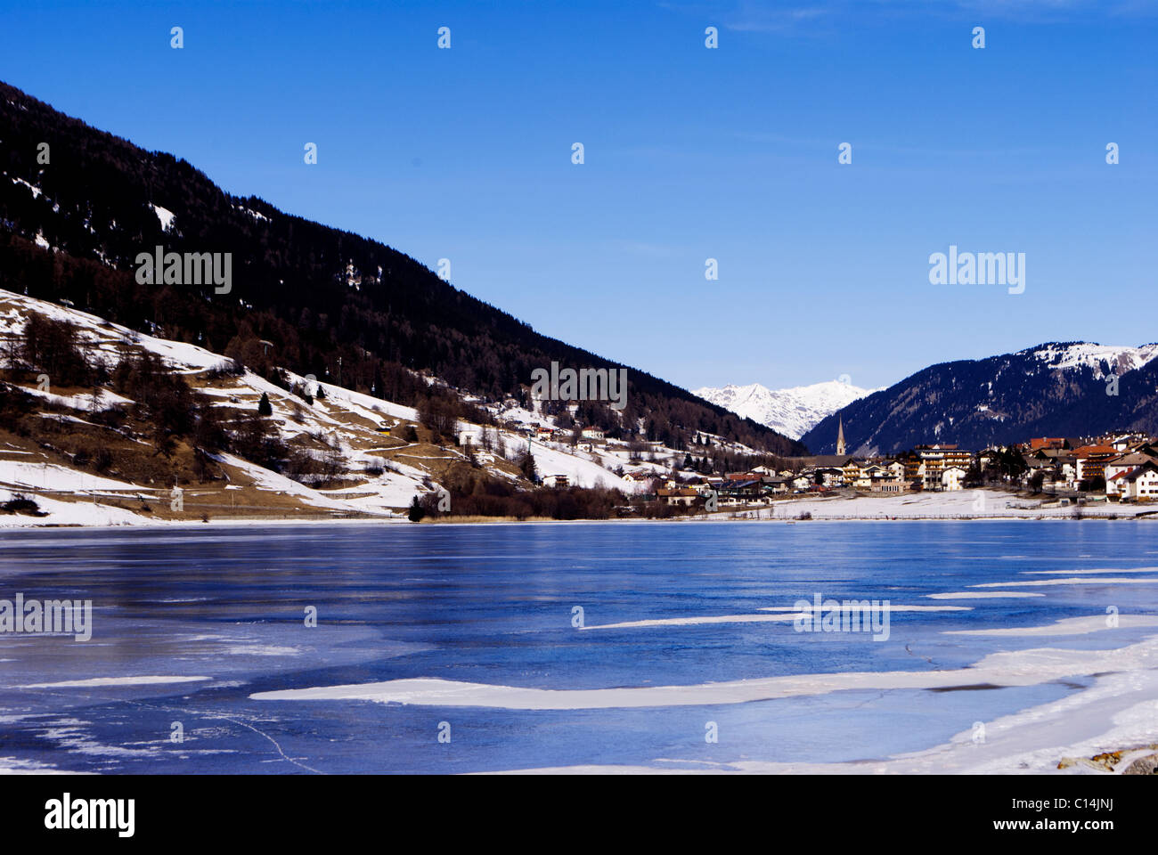 frozen lake in winter with the Alpine mountains and blue sky Stock ...