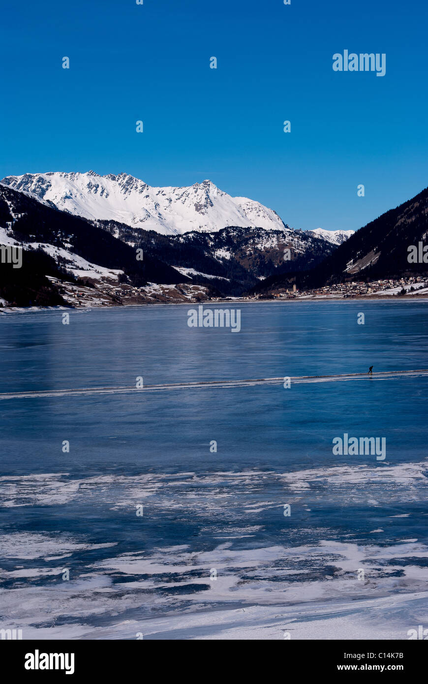 frozen lake in winter with the Alpine mountains and blue sky Stock ...