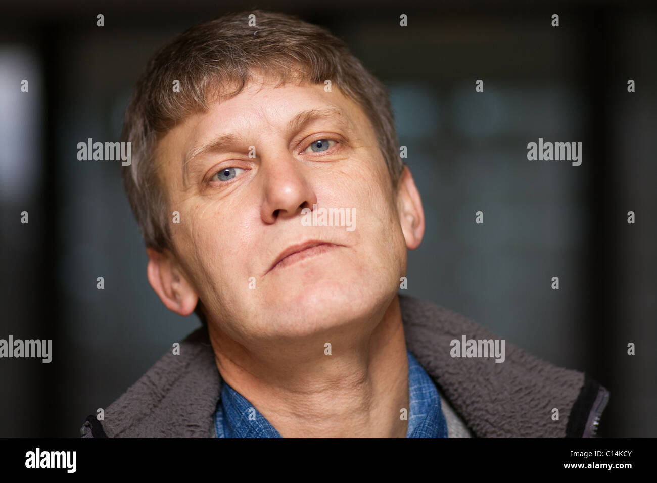 Casual portrait of a mature man; blurred background Stock Photo - Alamy