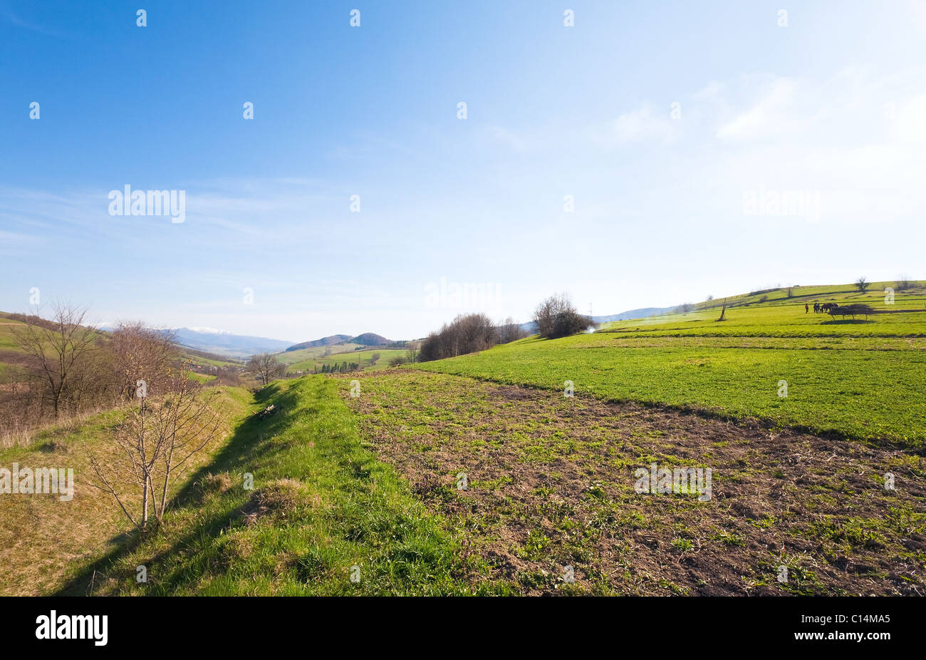 Spring mountain country valley view with farm fields and mountains in ...