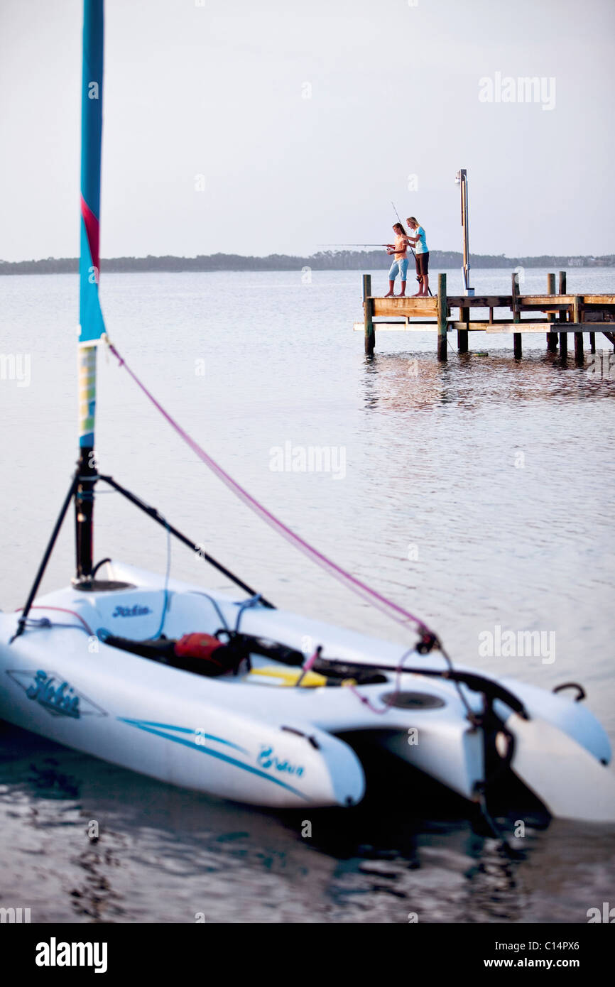 Two girls fish off a pier on the Santa Rosa Sound, Pensacola Beach ...