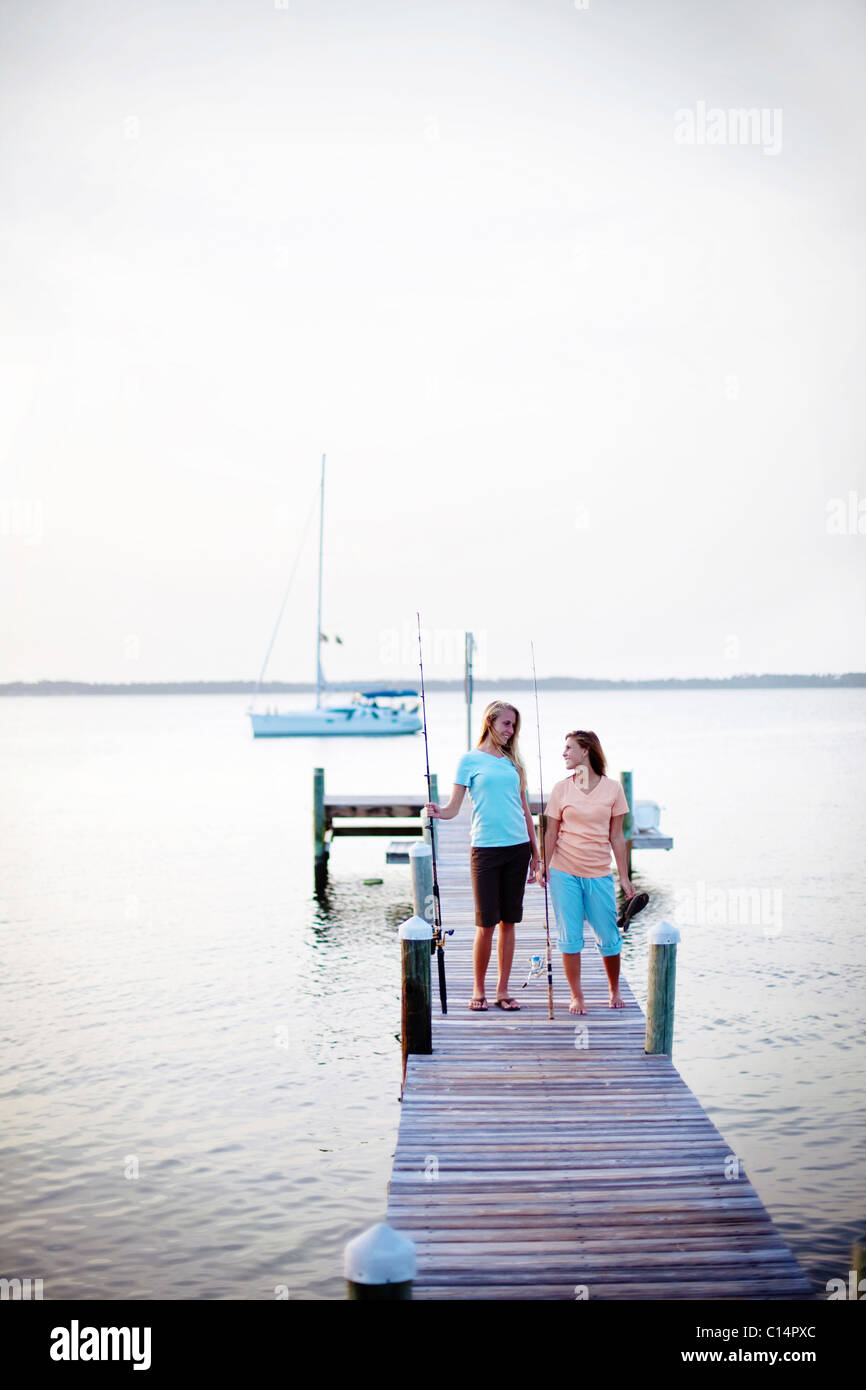 Two girls talk on a pier after fishing in Santa Rosa Sound, Pensacola ...