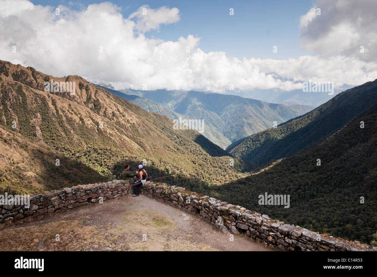A young couple enjoys themselves at a lookout point along the Inca ...