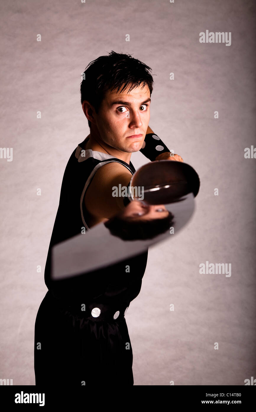 A young man practicing wushu poses with a broadsword Stock Photo - Alamy