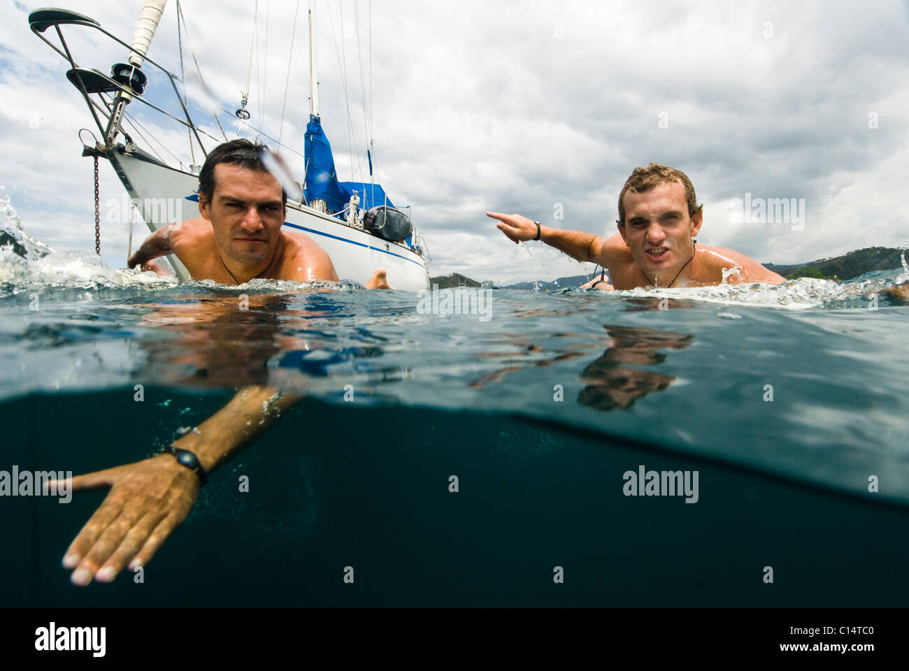 Two guys heading out for surf in Costa Rica Stock Photo - Alamy