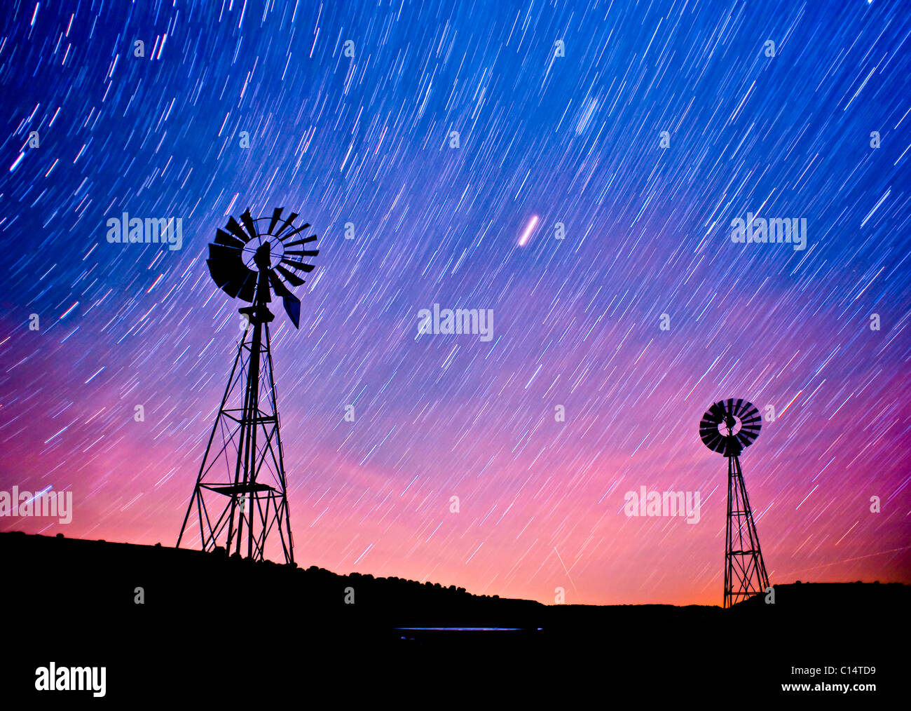 Two windmills with star trails in the sky. La Junta, Colorado Stock ...