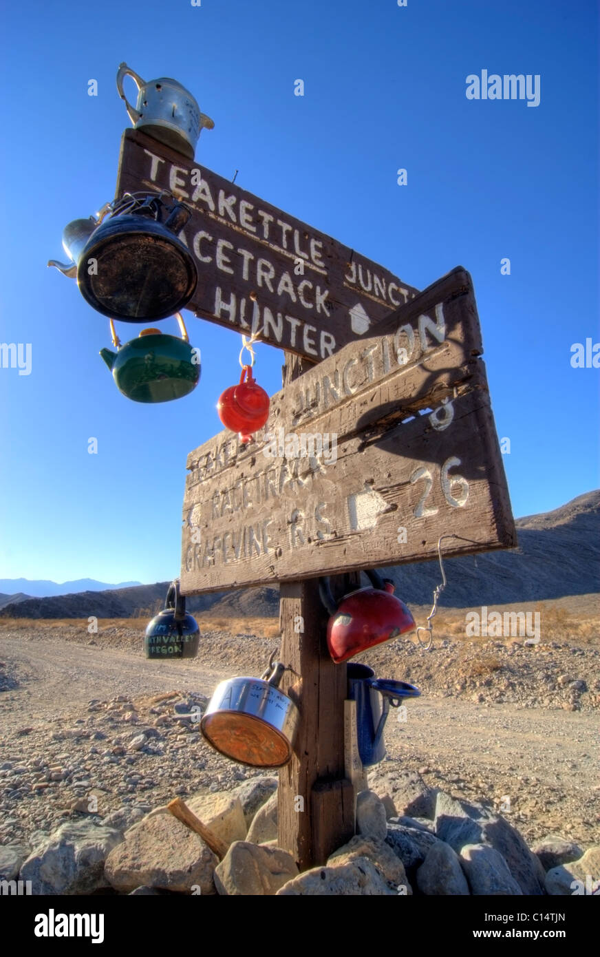Teakettles hang on the road sign at Teakettle Junction in Death Valley ...