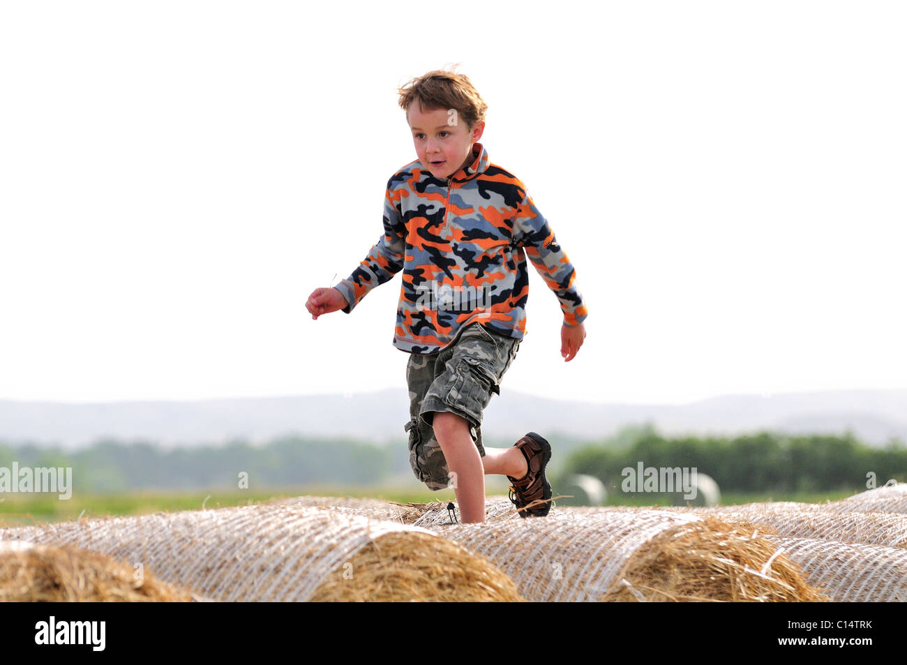 young child playing on hay bales Stock Photo - Alamy