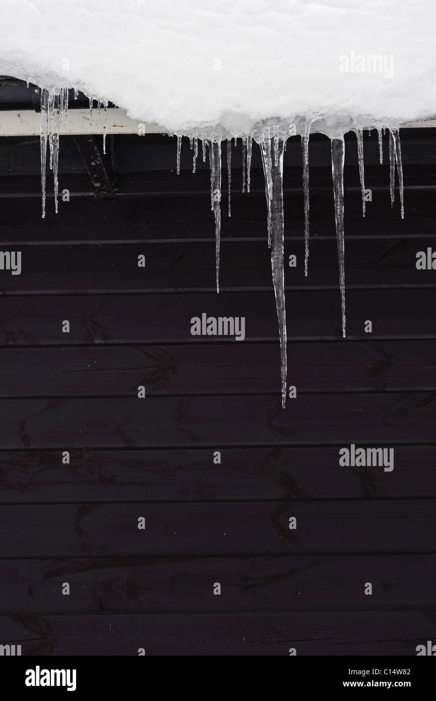 Icicles hanging from roof, Sweden Stock Photo - Alamy