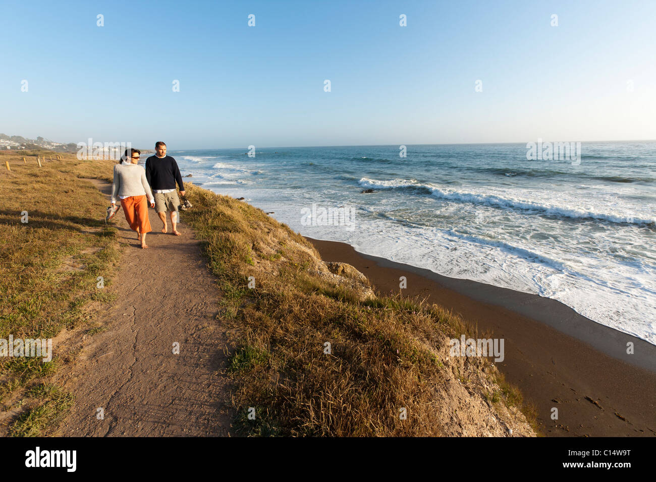 Boardwalk path along beach cliffs overlooking Pacific Ocean at ...