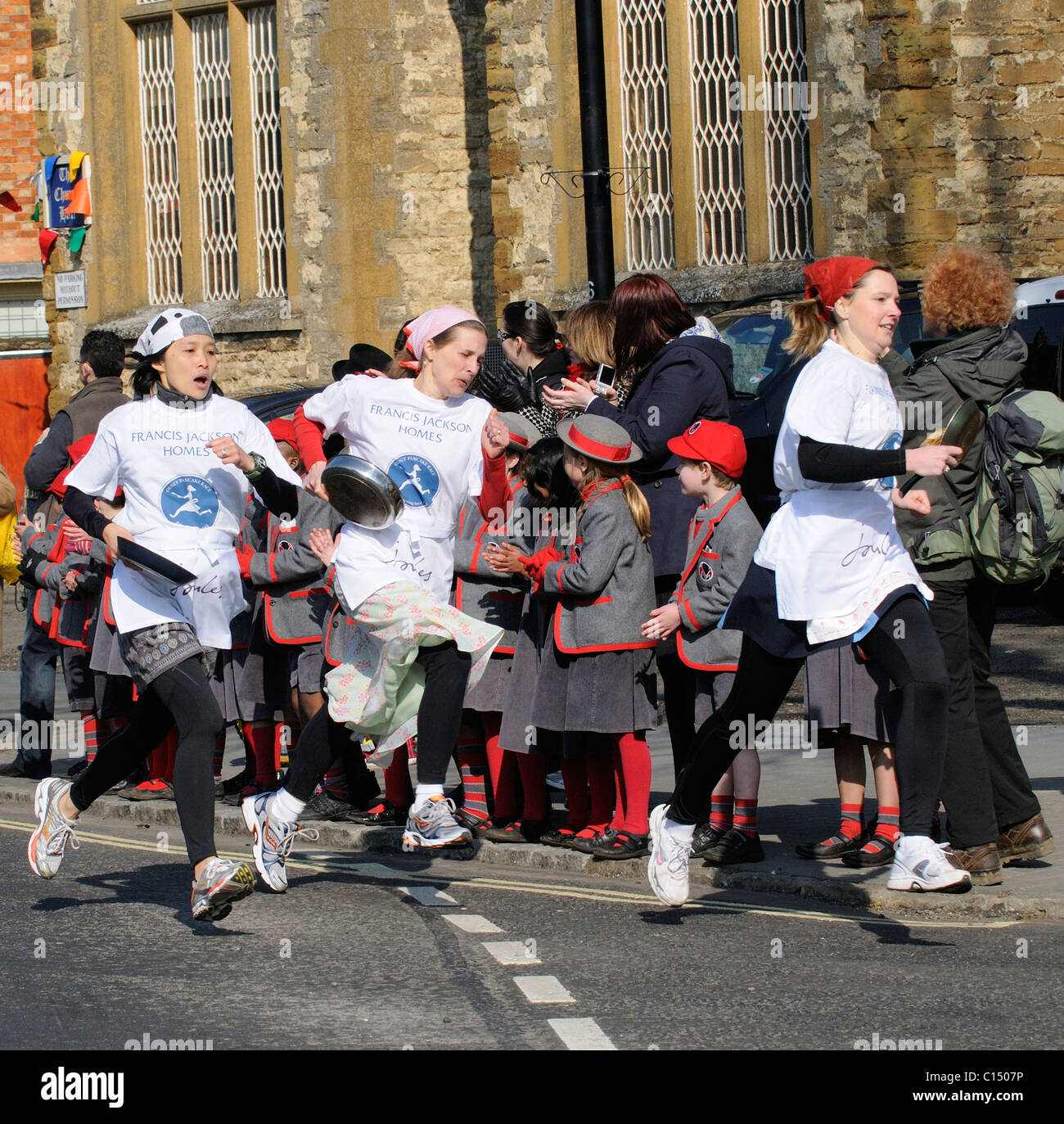 Pancake Race in Olney Buckinghamshire competitors race with their pans ...