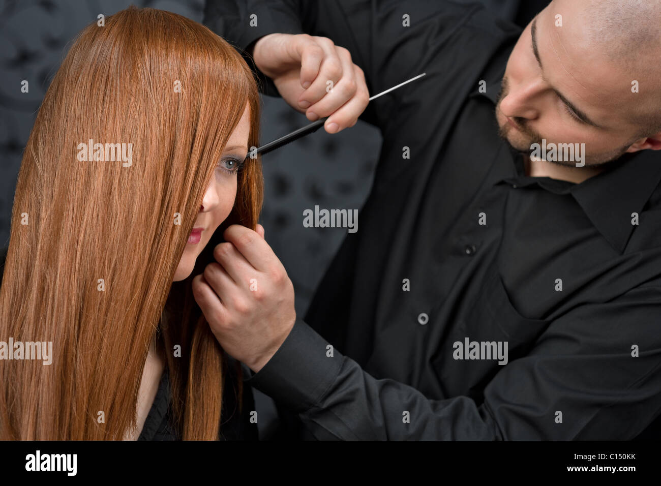 Professional hairdresser with long red hair fashion model at luxury ...