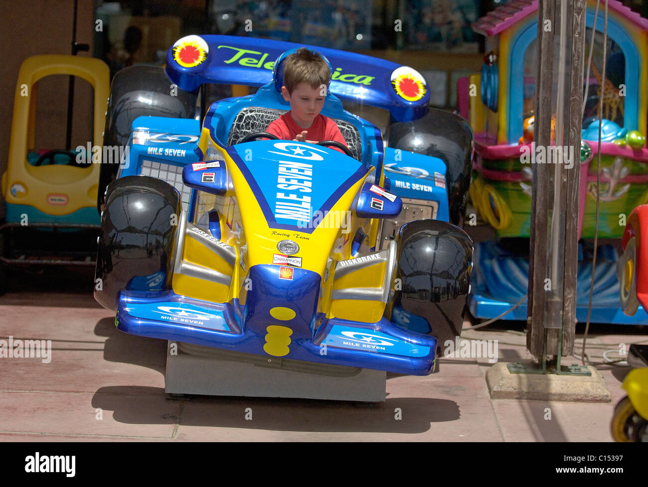 Child sitting in toy racing car Stock Photo - Alamy