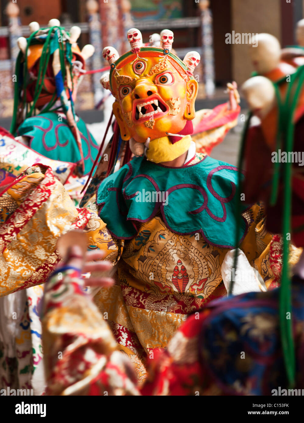 Masked and costumed monastic dancer at a festival in the Trongsa dzong in central Bhutan Stock ...