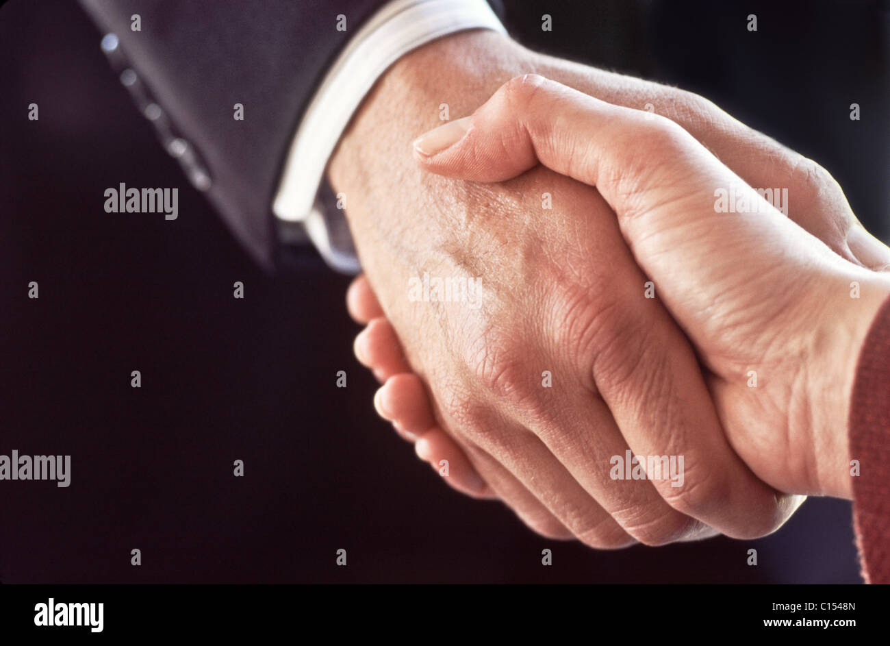 Businessman and businesswoman shaking hands, close-up Stock Photo - Alamy