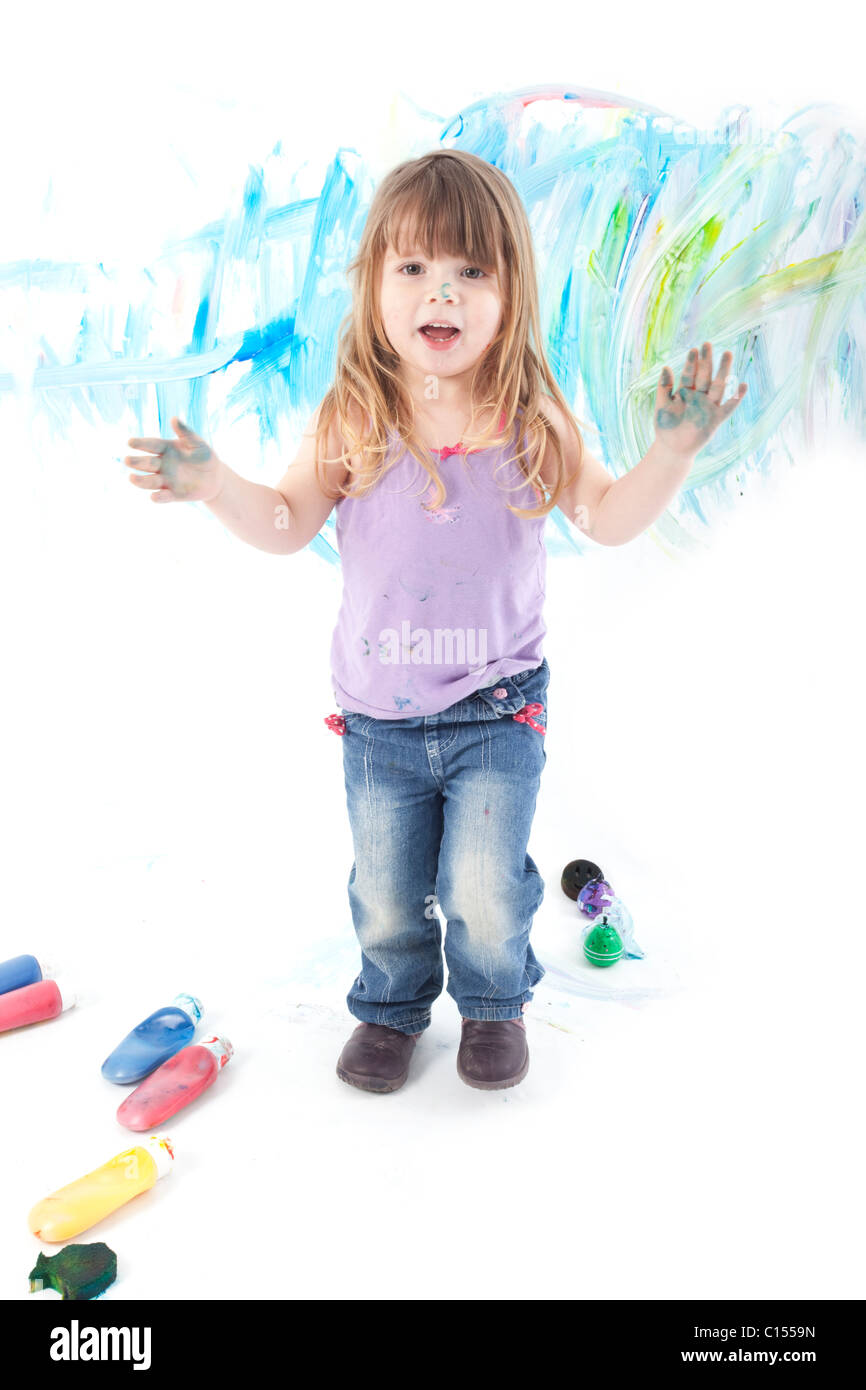 child painting with paint on herself looking at camera Stock Photo - Alamy