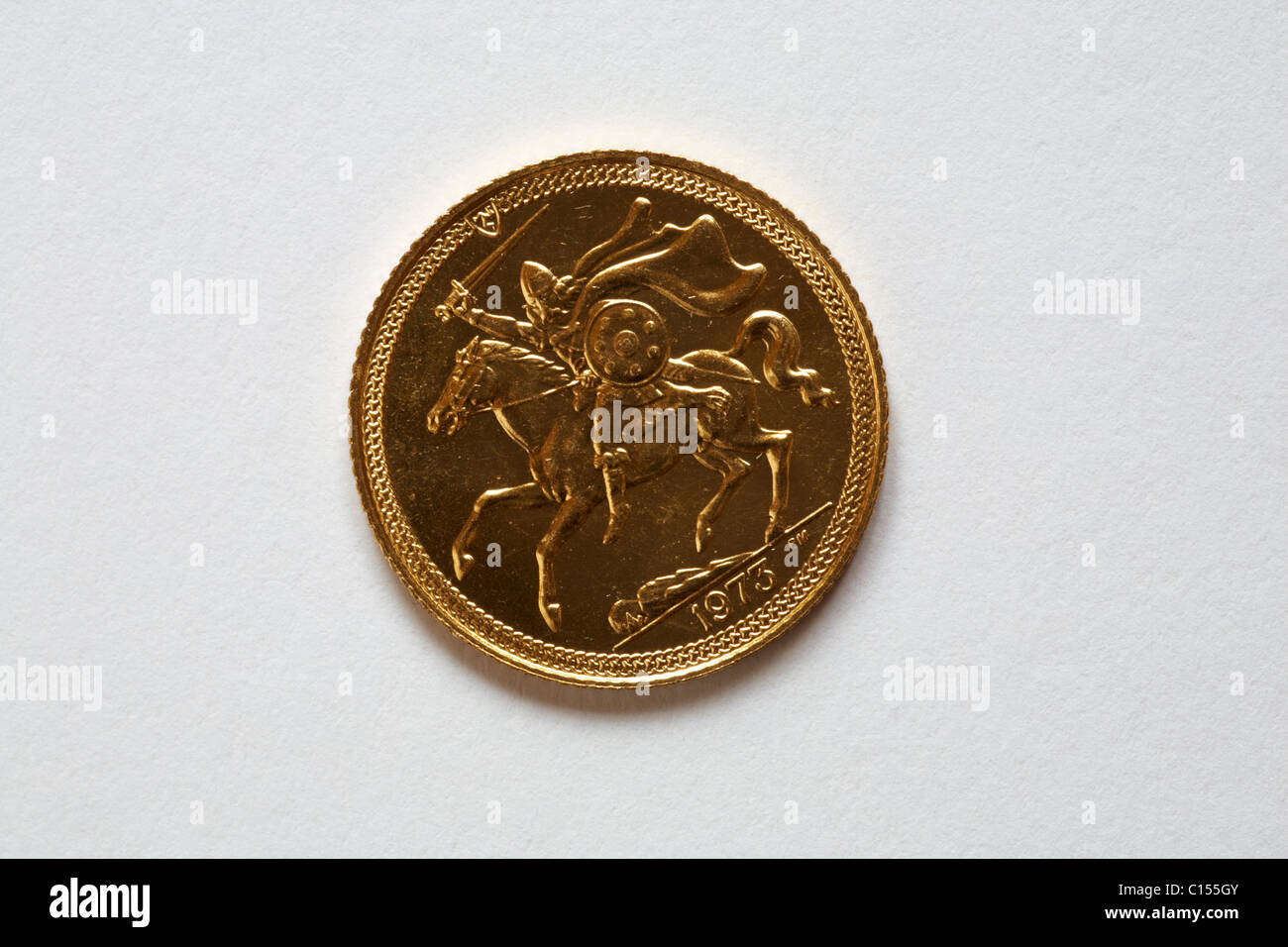 One gold half sovereign showing tail side isolated on white background ...