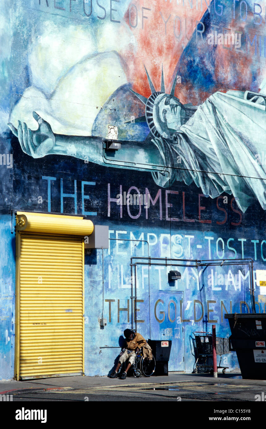 Homeless handicapped man in wheelchair sleeps under grafitti mural of ...