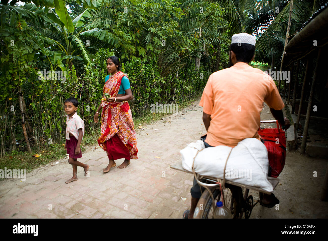 Mother and son walking along path in rural Bangladesh Stock Photo - Alamy