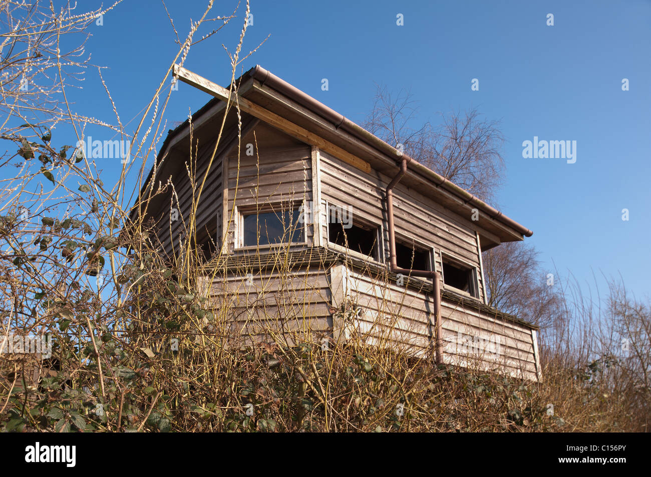 Bird hide in early British Spring time built with recycled materials ...