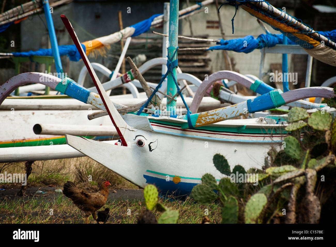 A traditional Balinese outrigger sailing fishing boat, called a jukung ...